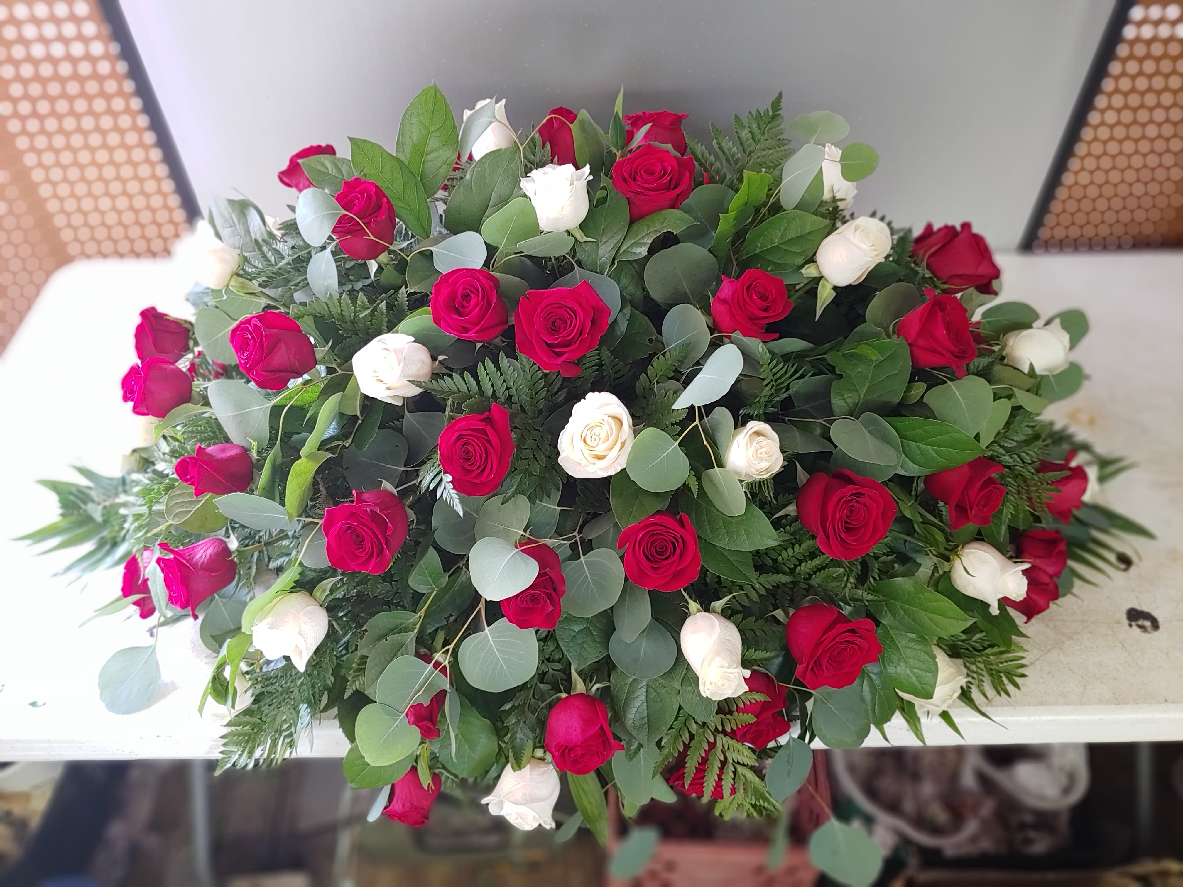 Red and white rose casket spray in Cincinnati, OH | Osterbrock Florist