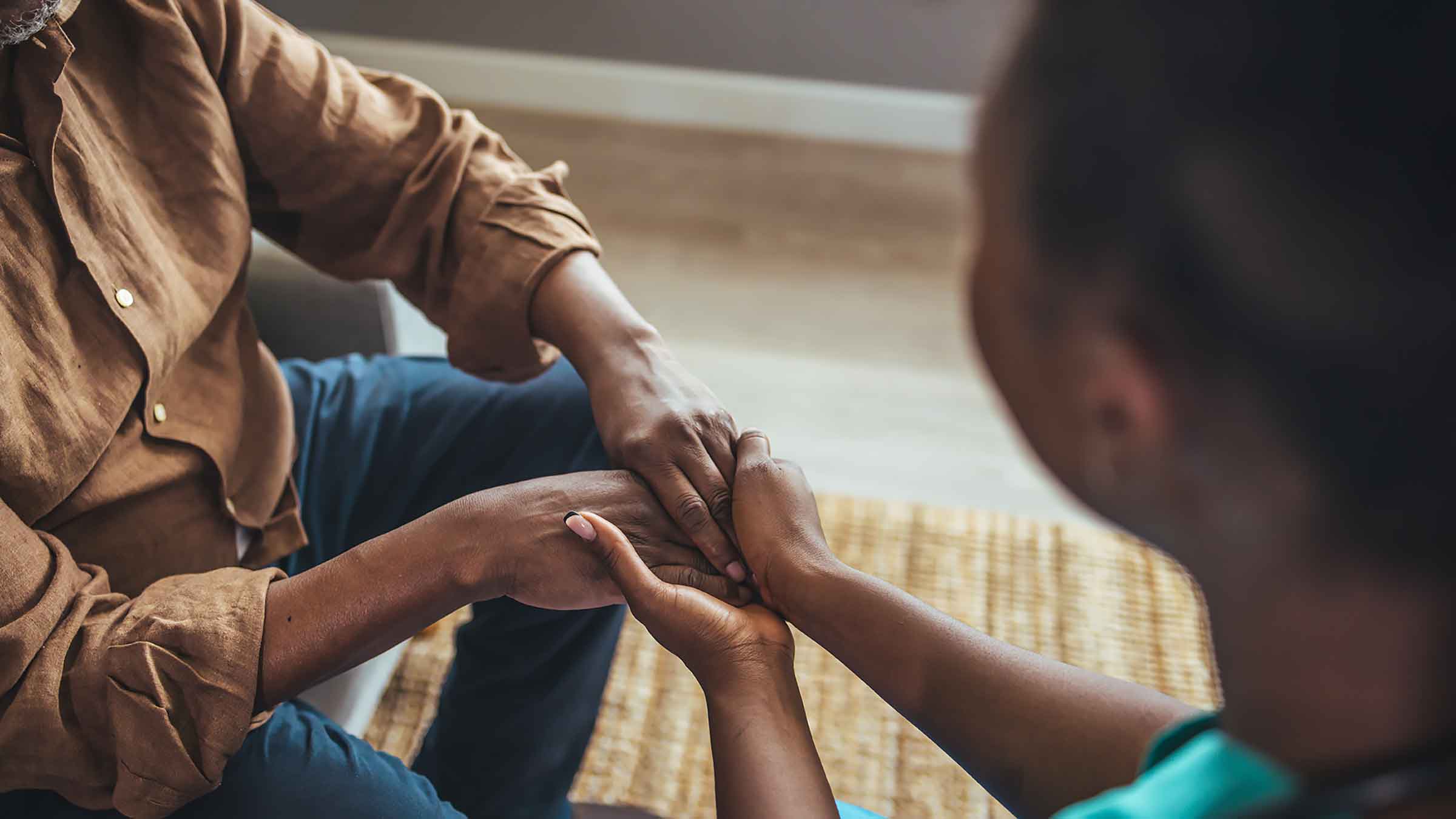 Two people hold hands
