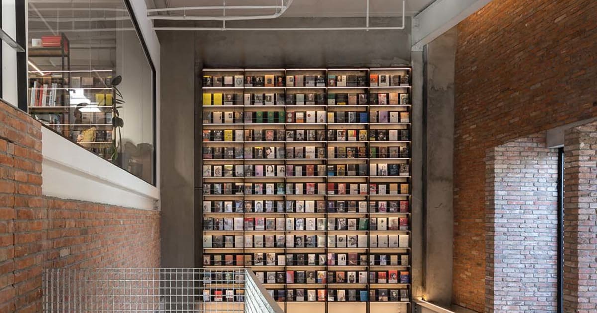 Industrial Library with Brick, Concrete, and Glass | Feel Design