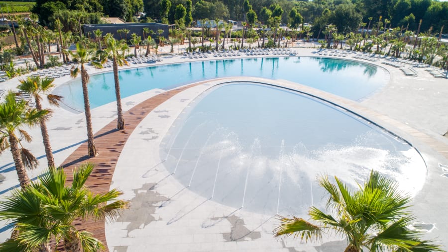 Gently sloping and surrounded by swaying palm trees, it’s a real scene ...