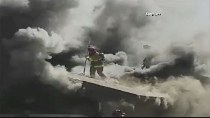 Dramatic video shows firefighter fall through roof