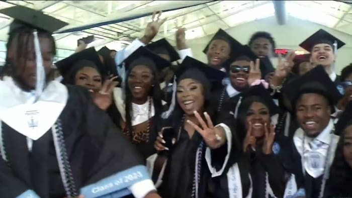 Ribault High School seniors walk across stage after receiving the ...