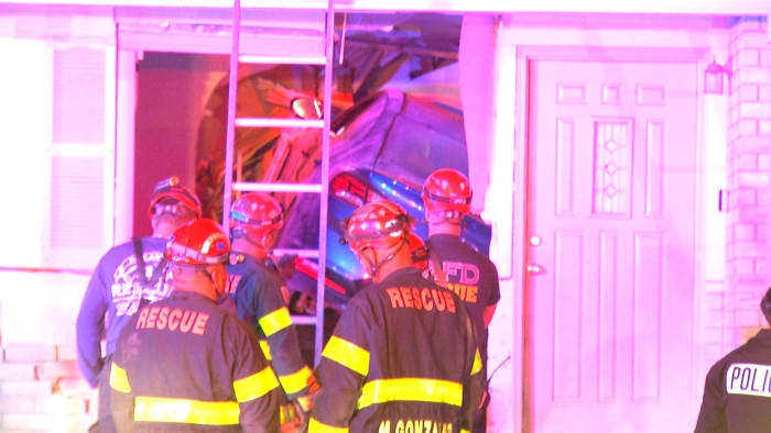 2 children, mother rescued by firefighters after car crashes into home ...