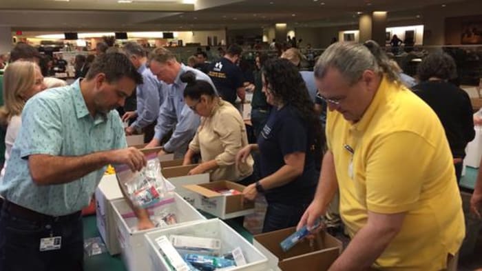 USAA employees help assemble care packages for deployed servicemen and ...
