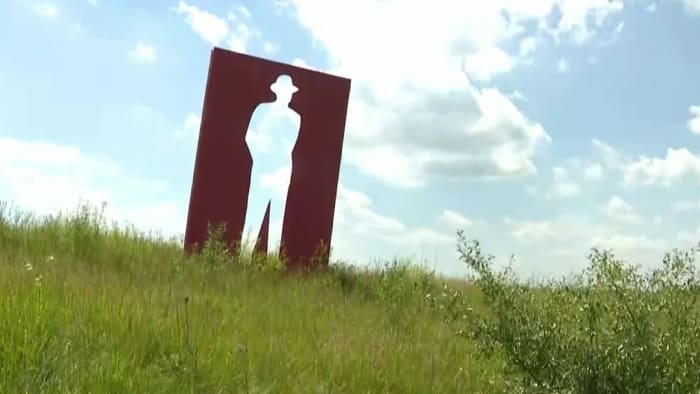 We finally know who cut down the iconic I-96 ‘orange man’ sculpture