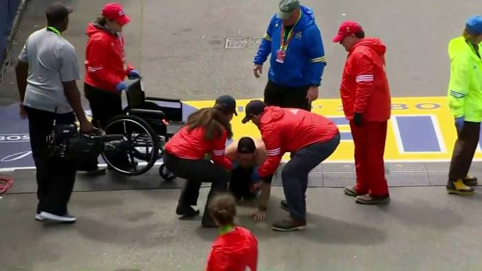 Image of marine crawling across finish line at Boston Marathon captures ...