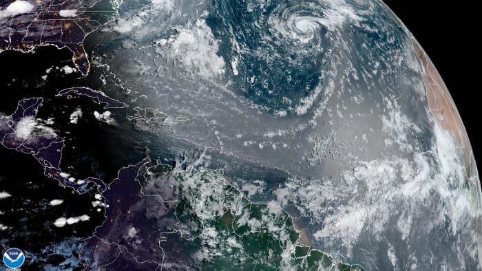 How does Saharan dust affect tropical development?