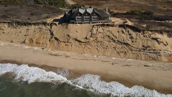 Wind and water are slowly taking this luxury house overlooking Cape Cod Bay