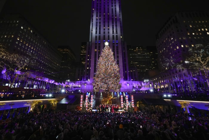 Iconic Christmas tree at Rockefeller Center illuminated in midst of pro ...