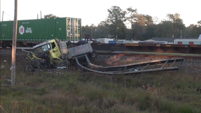 Driver narrowly escapes after train strikes 18-wheeler stuck on tracks ...
