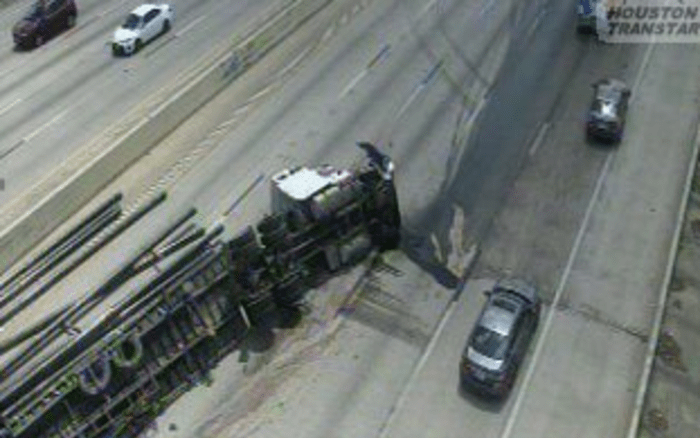 18-wheeler overturns on IH-610, sending oil, pipes across road