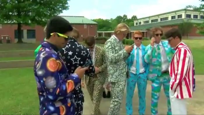 High school students wear funky suits to prom