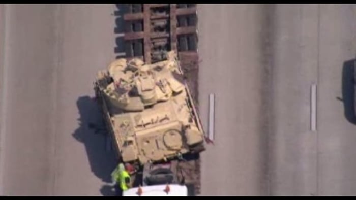 Armored military vehicle falls off trailer on North Loop