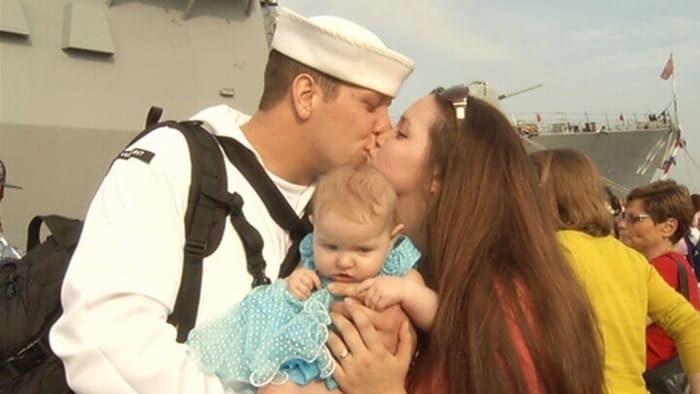Navy sailors return from sea to meet newborn babies for the 1st time
