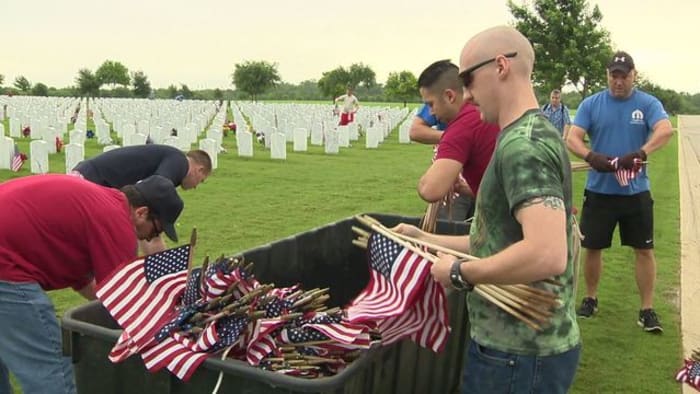 Volunteers reflect on sacrifice, remove flags at Fort Sam cemetery