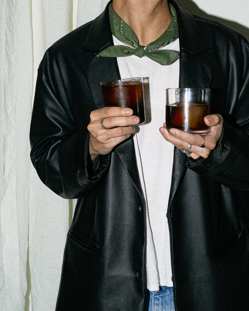 Photograph of a stylish man with a green scarf holding two prepared ...