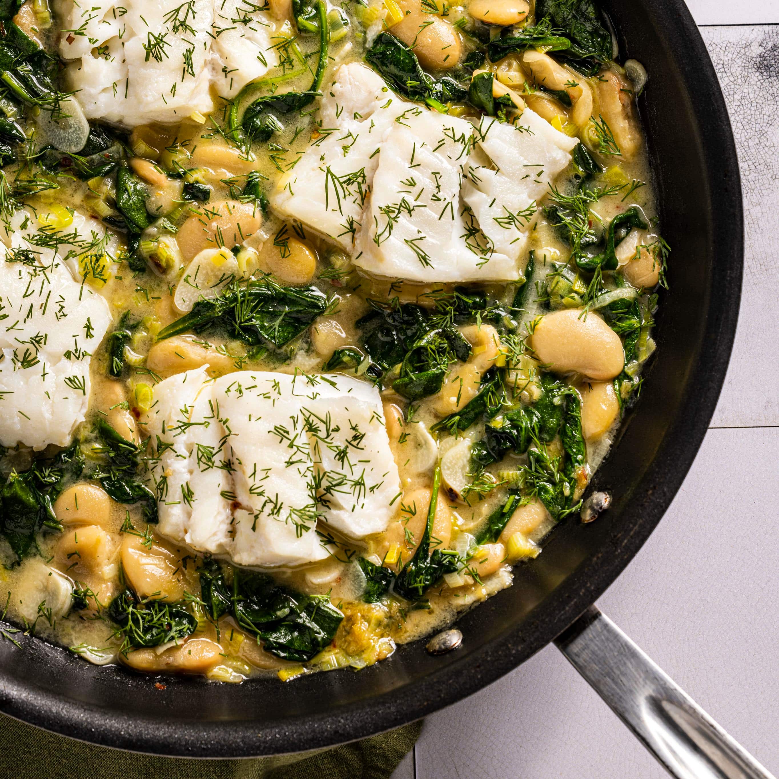 Skillet Poached Cod with Spinach and Butter Beans | America's Test Kitchen