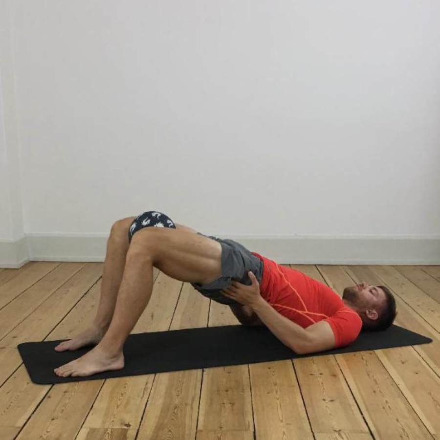 Squeeze ball between knees