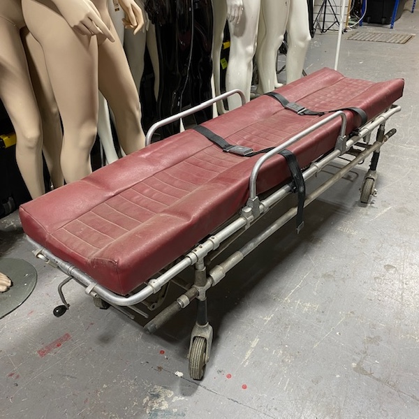 Red Medical/Ambulance Adjustable Stretcher On Wheels | LONDON PROP HIRE