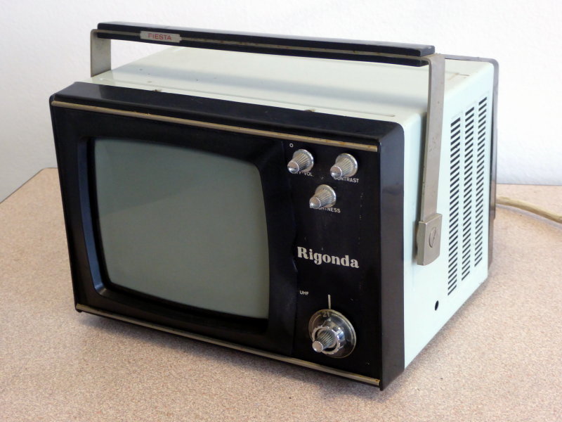 Ultra portable 1970s 6" black & white TV in light grey | Electro Props Hire