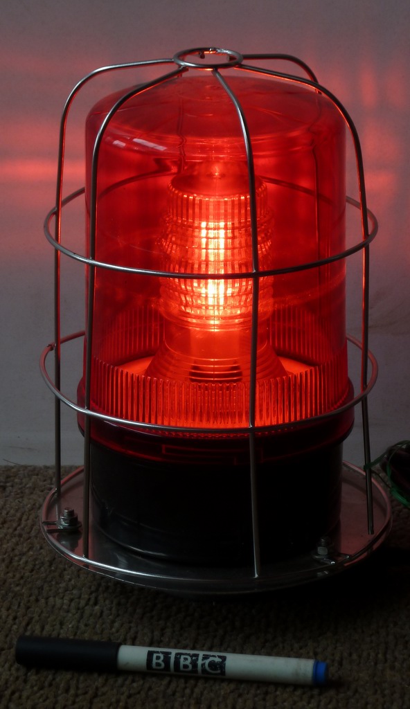 Caged red industrial warning beacon | Electro Props Hire