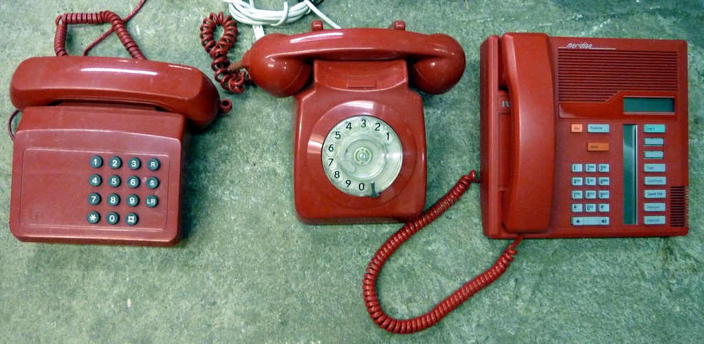 Selection of red desktop phones | Electro Props Hire