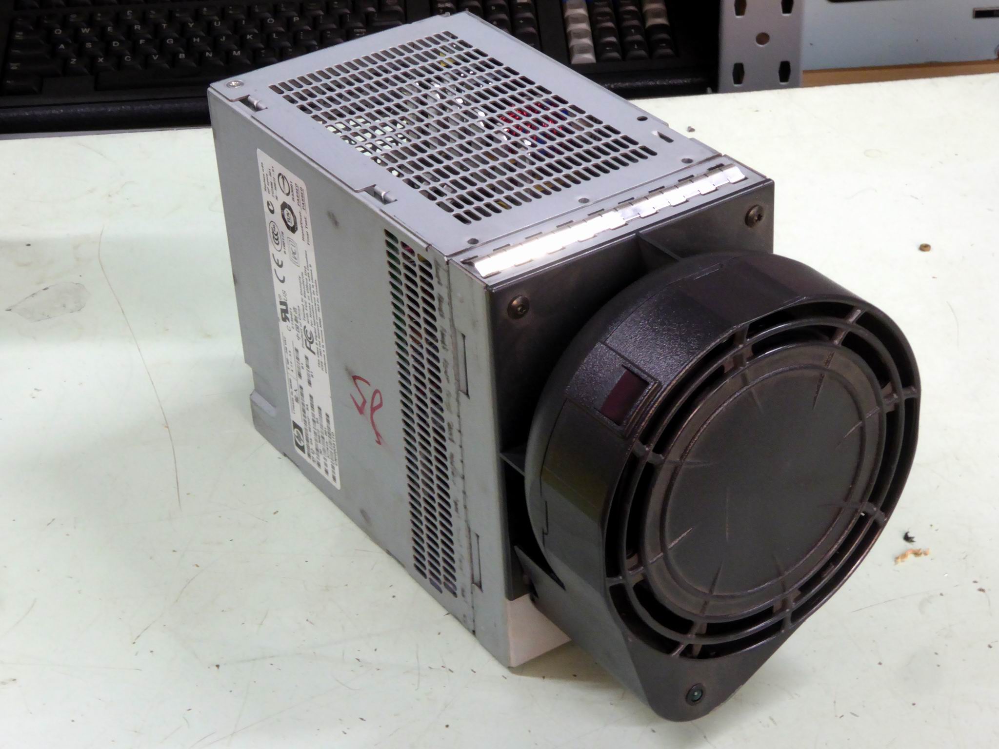 Technical looking computer power supply with large blower assembly ...