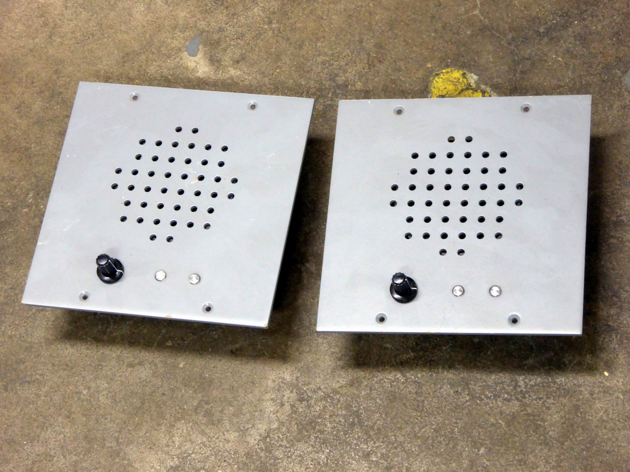 Light grey console mounting speaker panels with grills, volume control ...