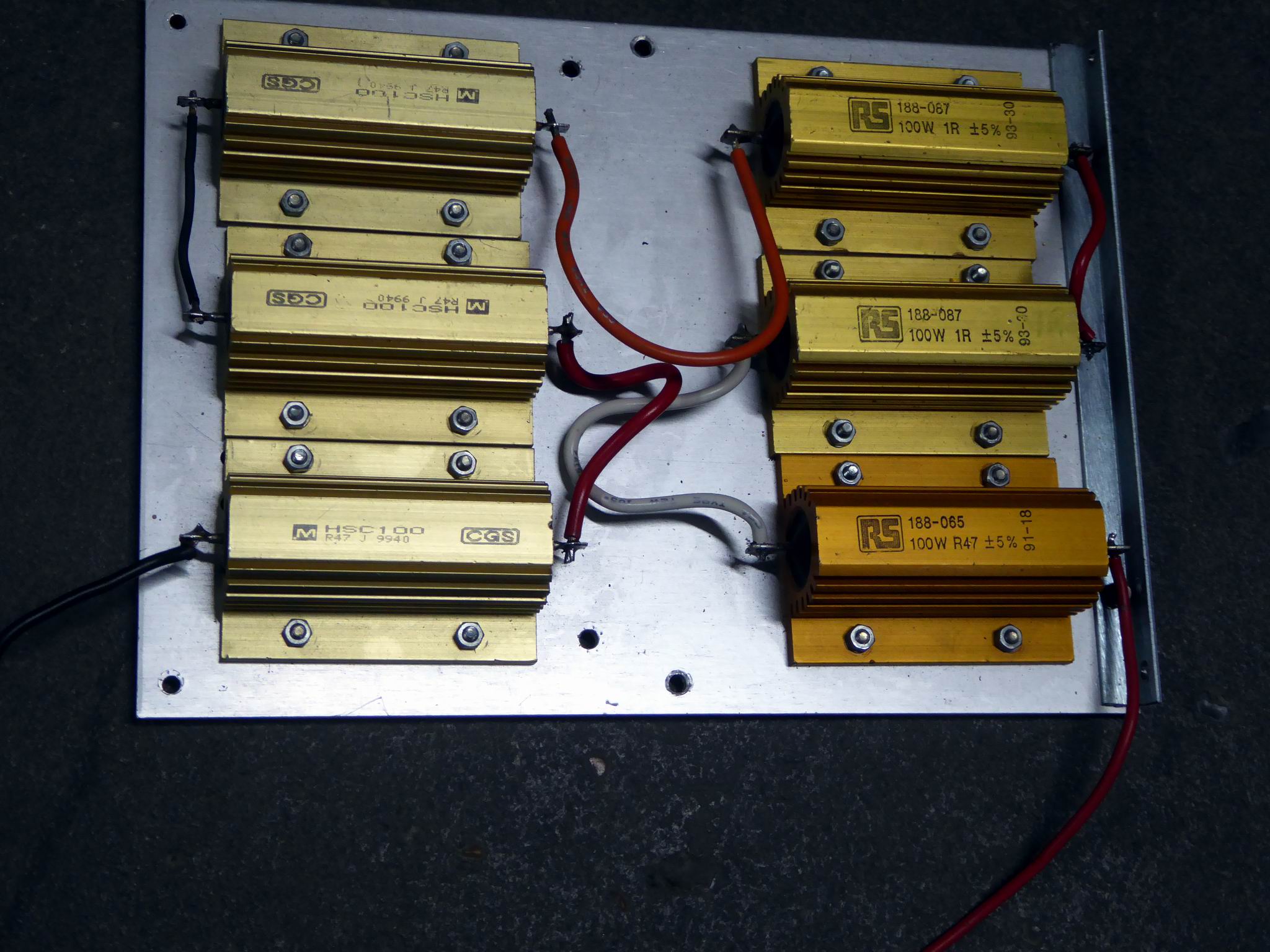 Goldy coloured power resistors on a heat sink with connecting wires ...