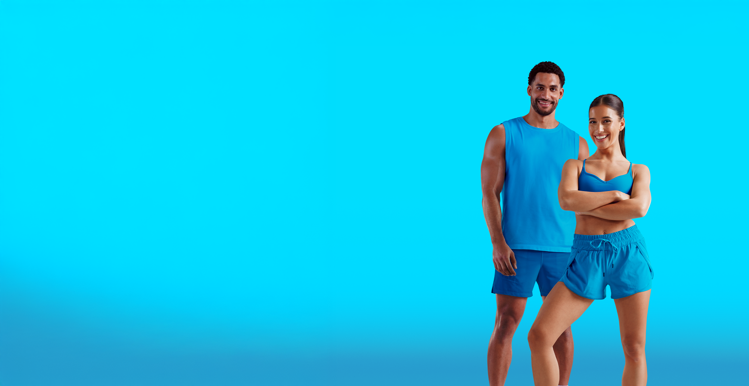 Sportler und Sportlerin posieren auf blauem Hintergrund