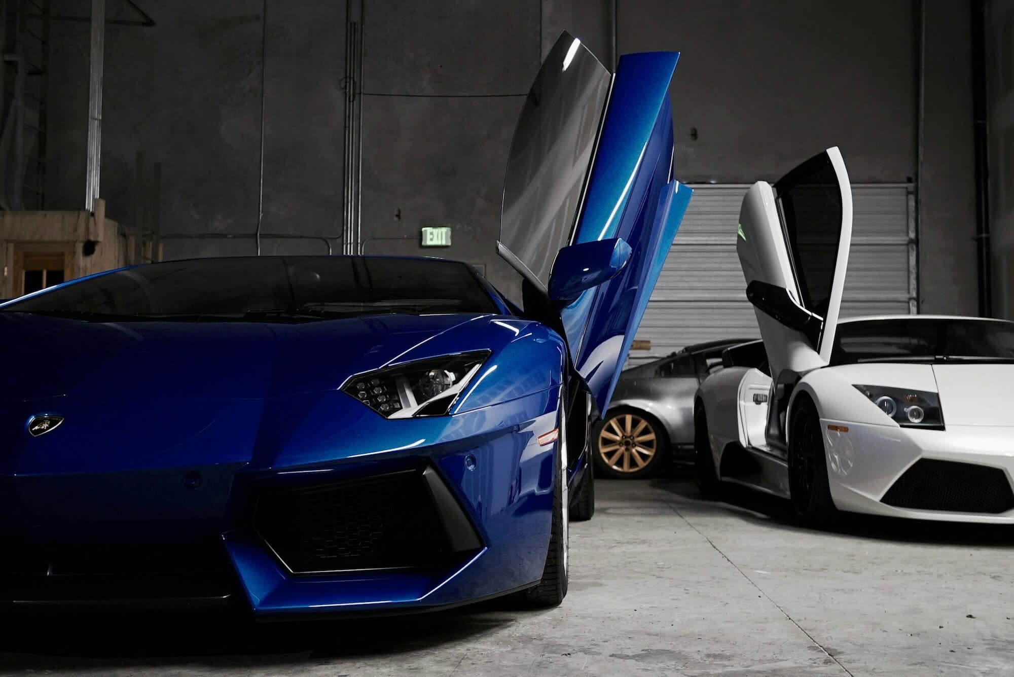 Lamborghini in a garage with the vehicle's doors open