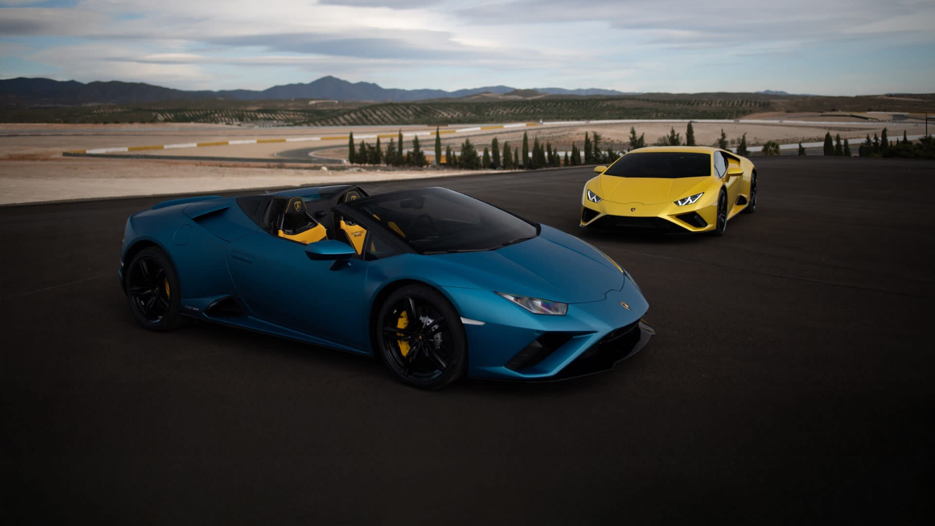A Lamborghini Huracán driving through the night next to the sea