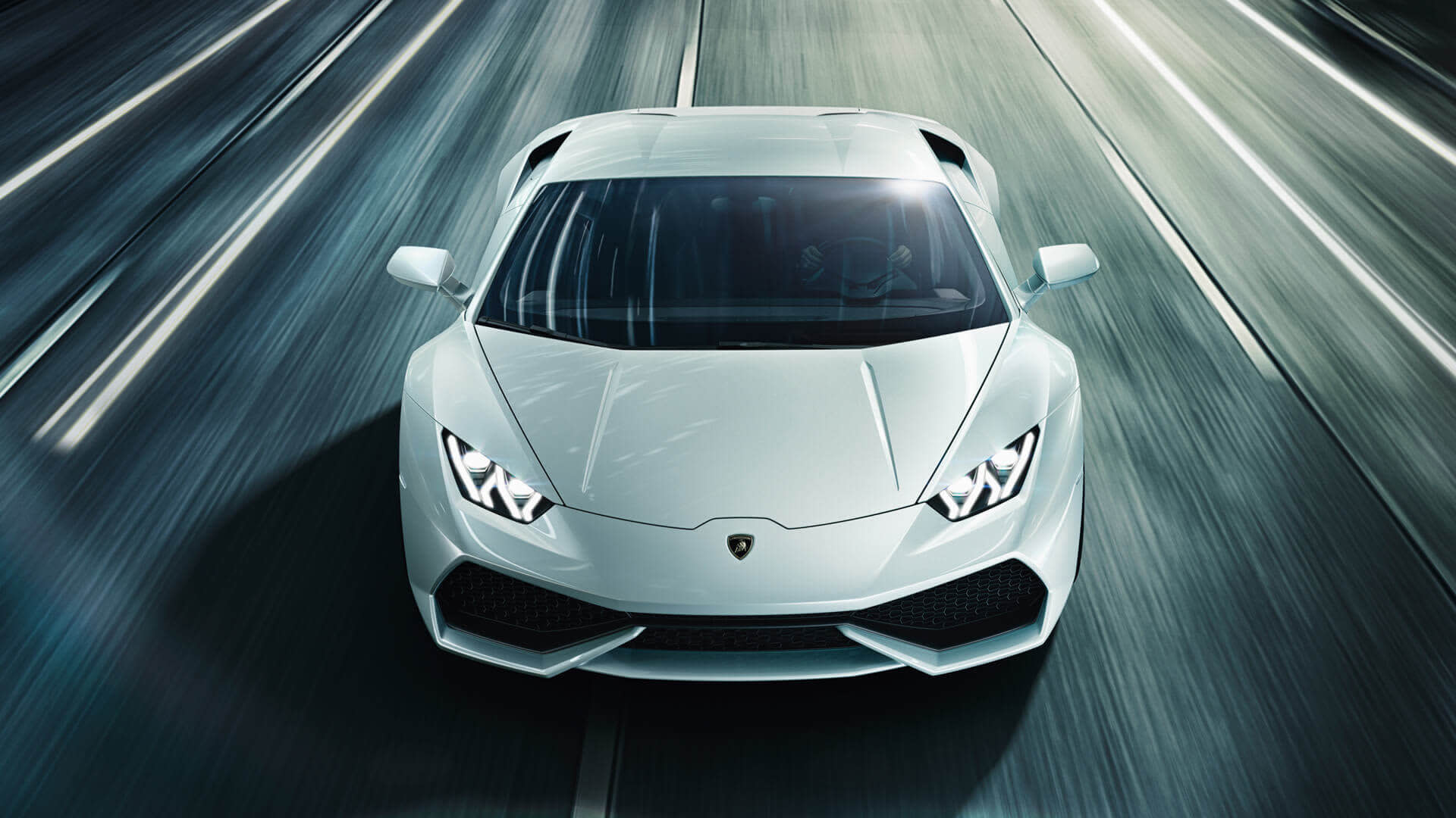 Lamborghini Huracán Coupé accelerating along a curved mountain pass at ...