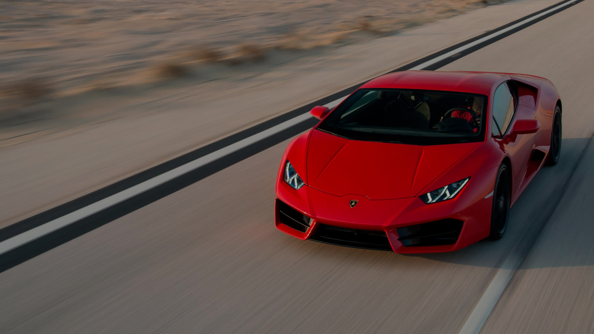 Front three-quarter view of a Lamborghini Huracán RWD driving on a dry ...