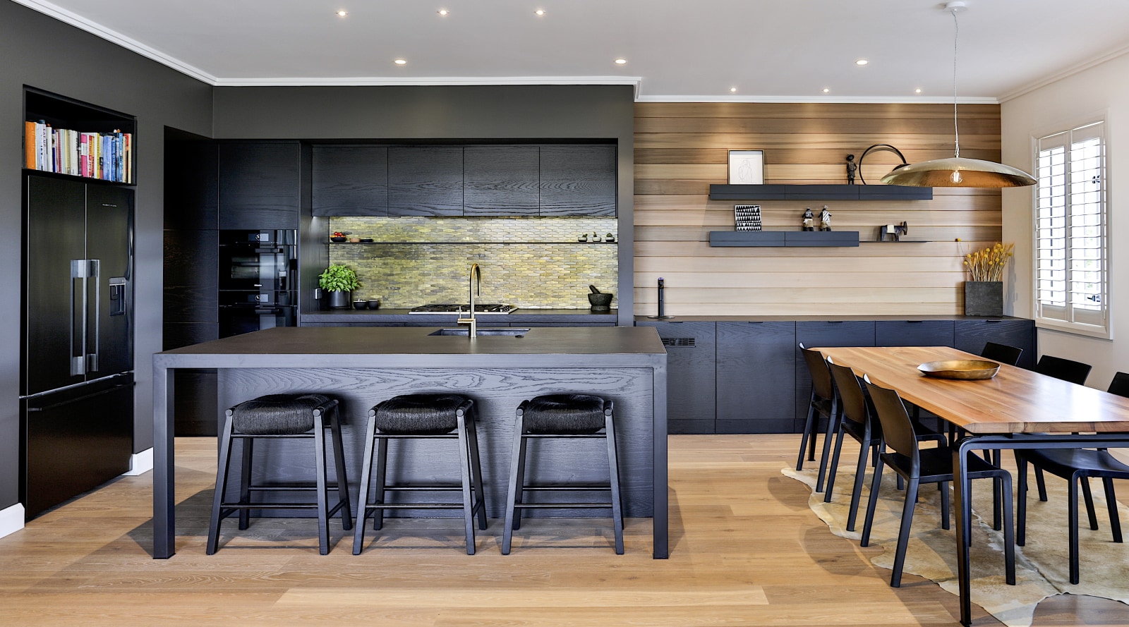 Black and wood dining table echoes adjacent… | Trends