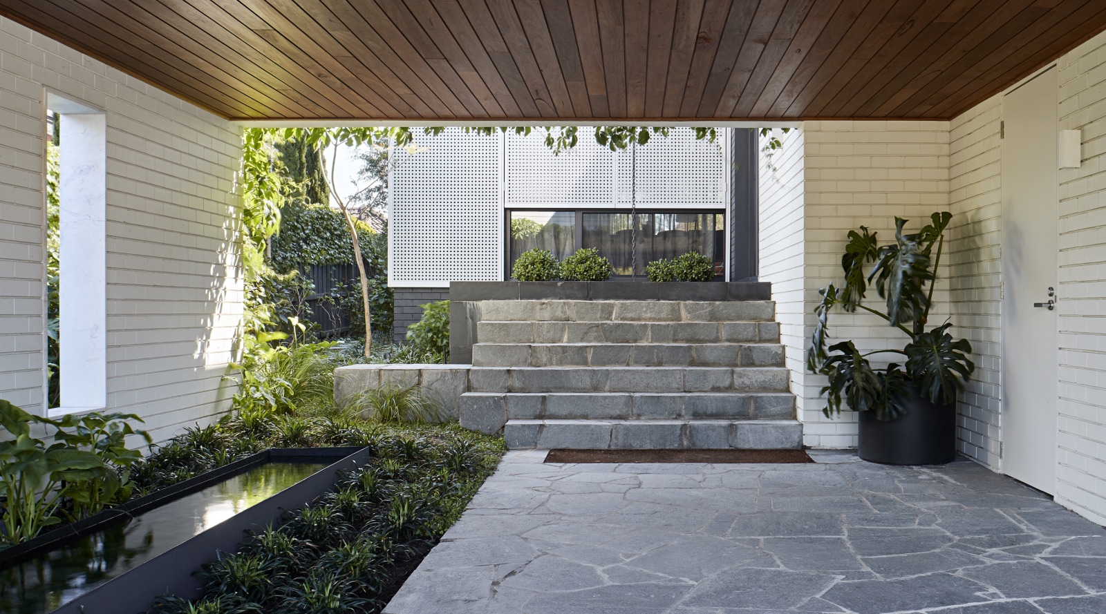Tranquil pool in under-house carport | Trends