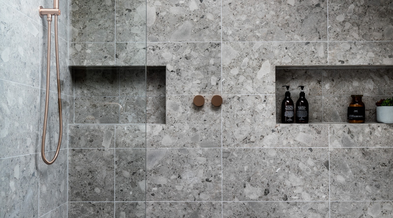 A grey stone shower sits in the gabled ceiling of… | Trends