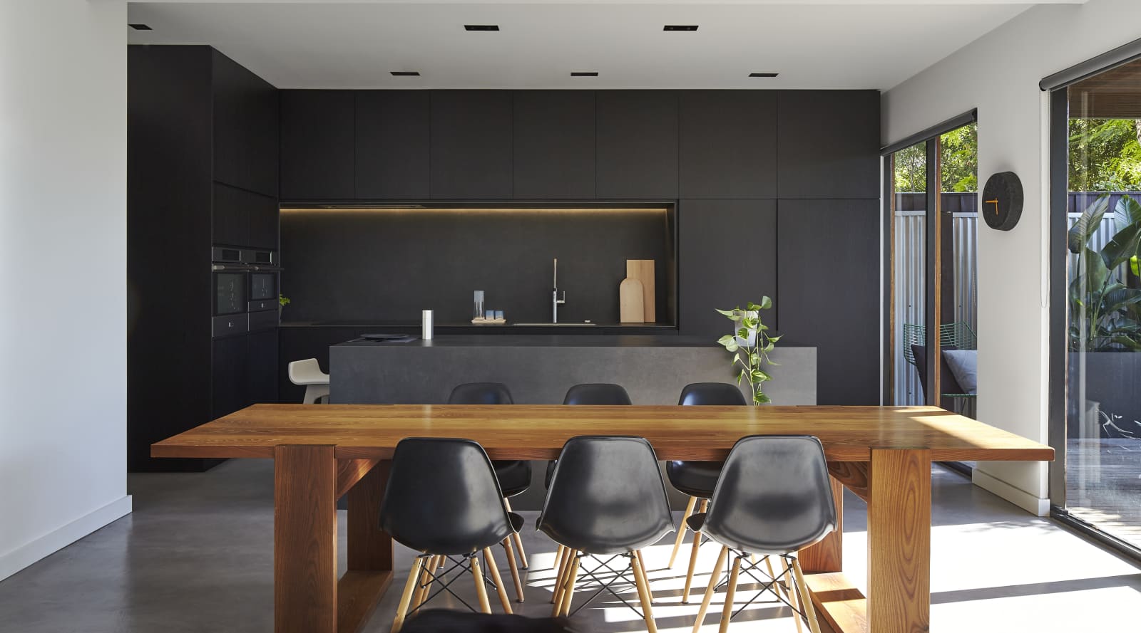 Sleek black kitchen by owner-architect with black… | Trends