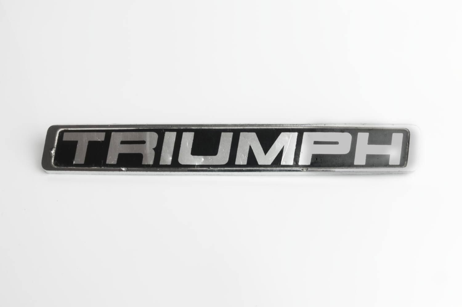 Wins International - 'Triumph' Front Panel Badge (Used)